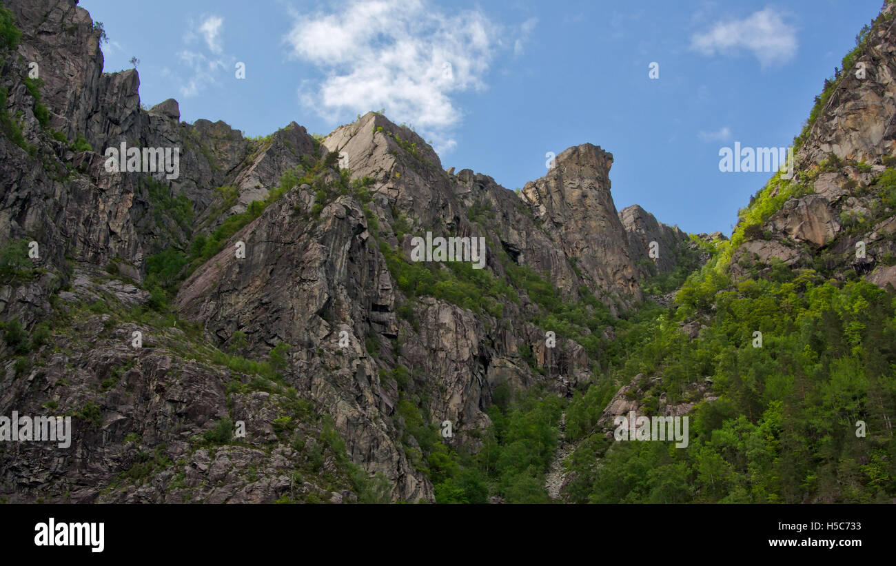 Granite rock formation with vegetation along a Norwegian fjord Stock ...