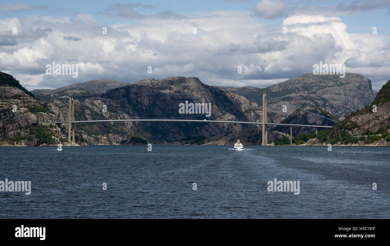 Yacht under a suspension bridge, entering lysefjord in norway Stock ...