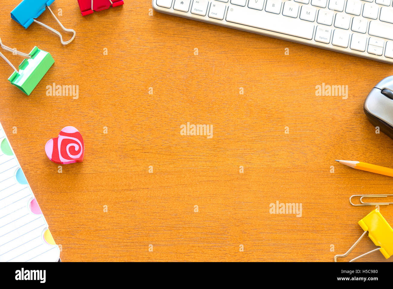 Overhead view of wood desktop space edged with keyboard and office ...