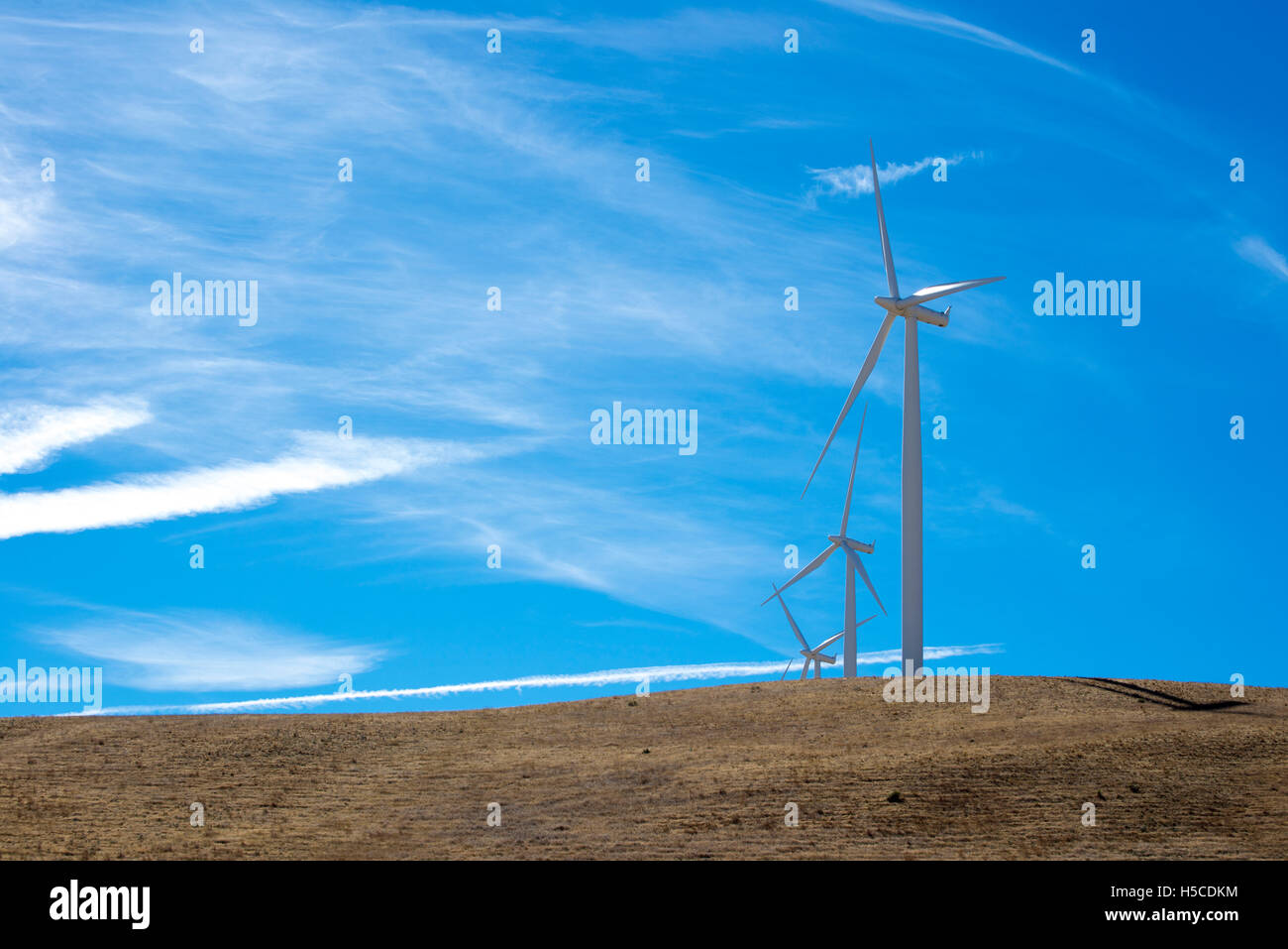 Three wind turbines on top of a hill Stock Photo - Alamy