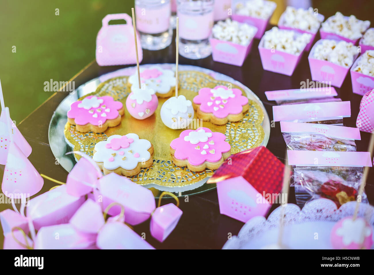 Dessert table at kids birthday party. Cake, candies, marshmallows ...