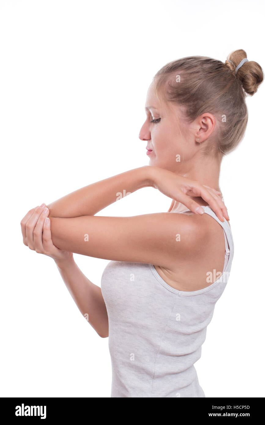 Elbow pain. Young woman holding her elbow, isolated on white background ...