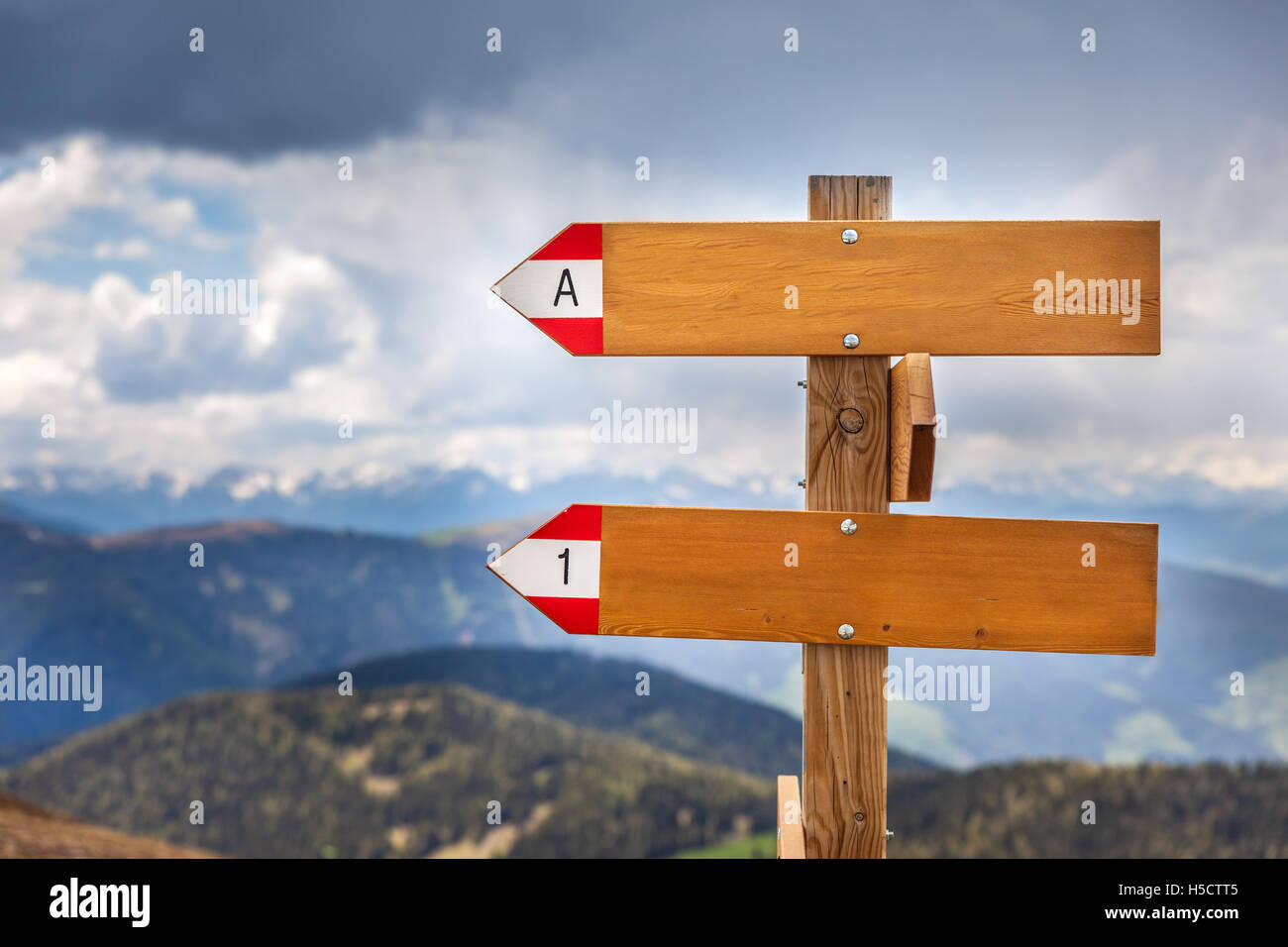 Empty wooden signpost in the mountains with bad weather Stock Photo - Alamy