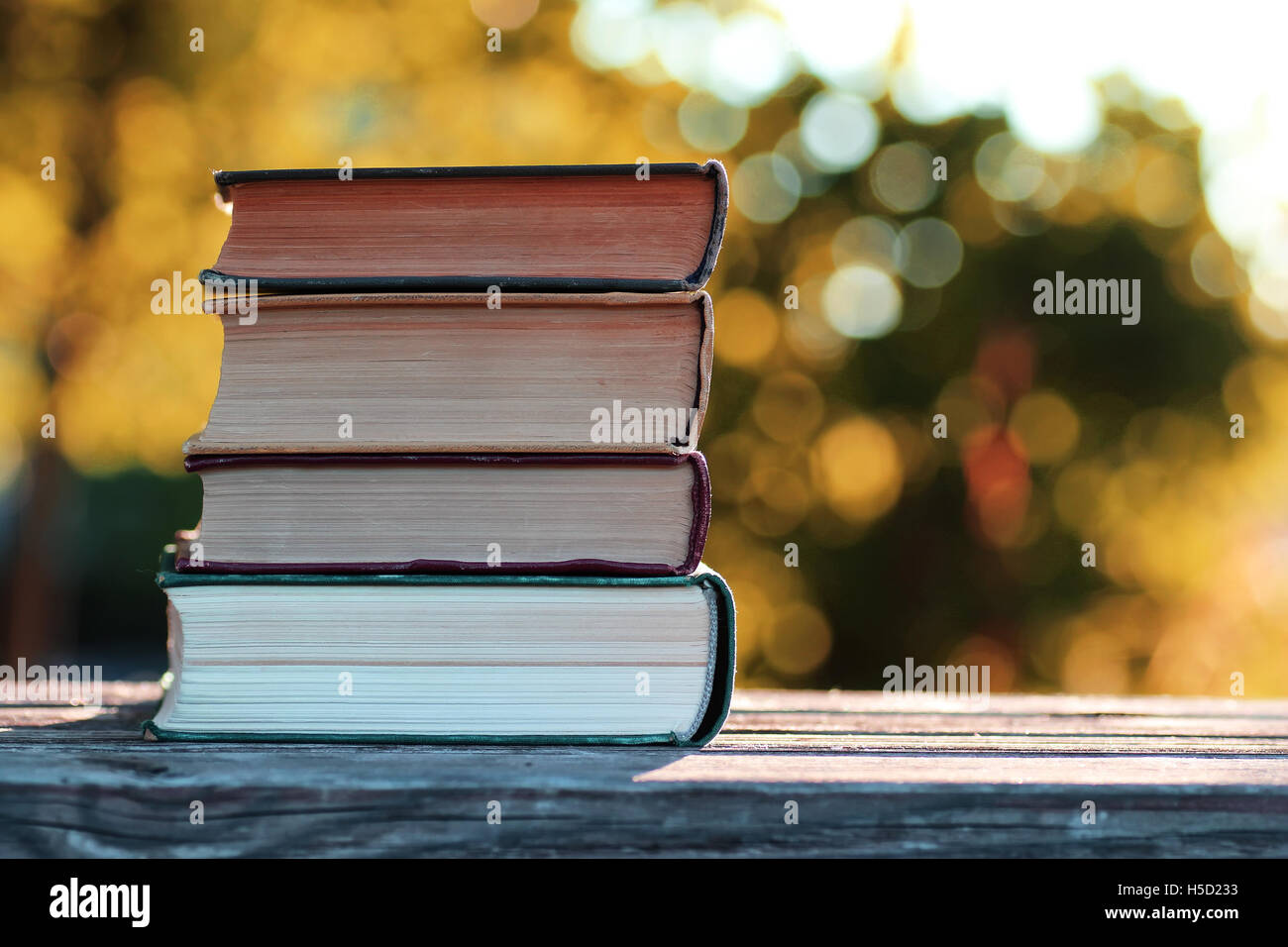 autumn book stack wooden outdoor Stock Photo - Alamy