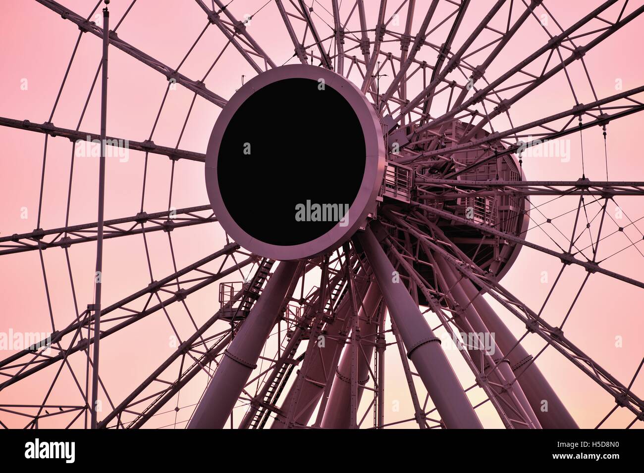 The glow from a muted sunrise shining through the hub of the Centennial ...