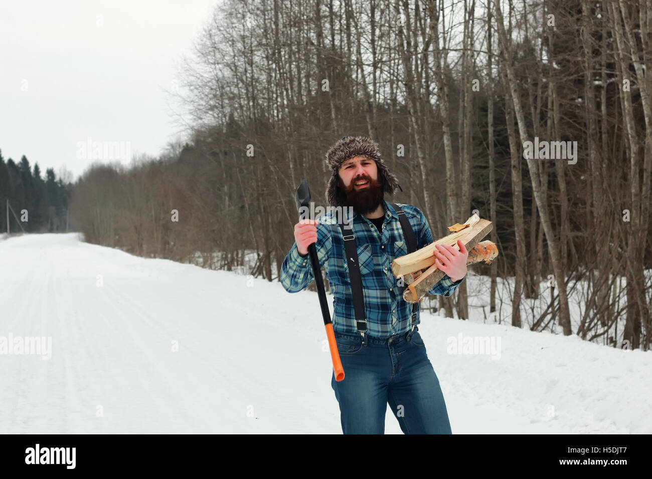 man in winter with axe Stock Photo - Alamy