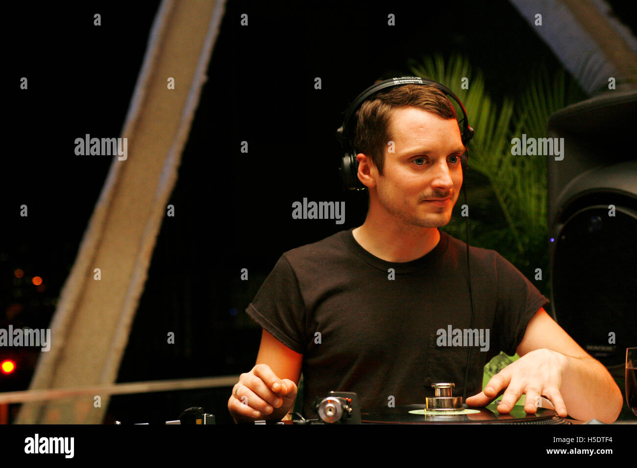 Actor Elijah Wood on a DJ table at Illuminate The Night at Art Basel on ...