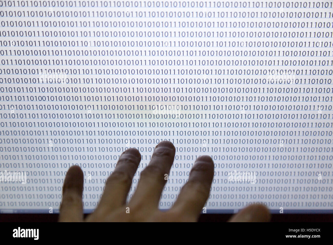 Black numbers zero and one as a texture on a white background, hand on ...