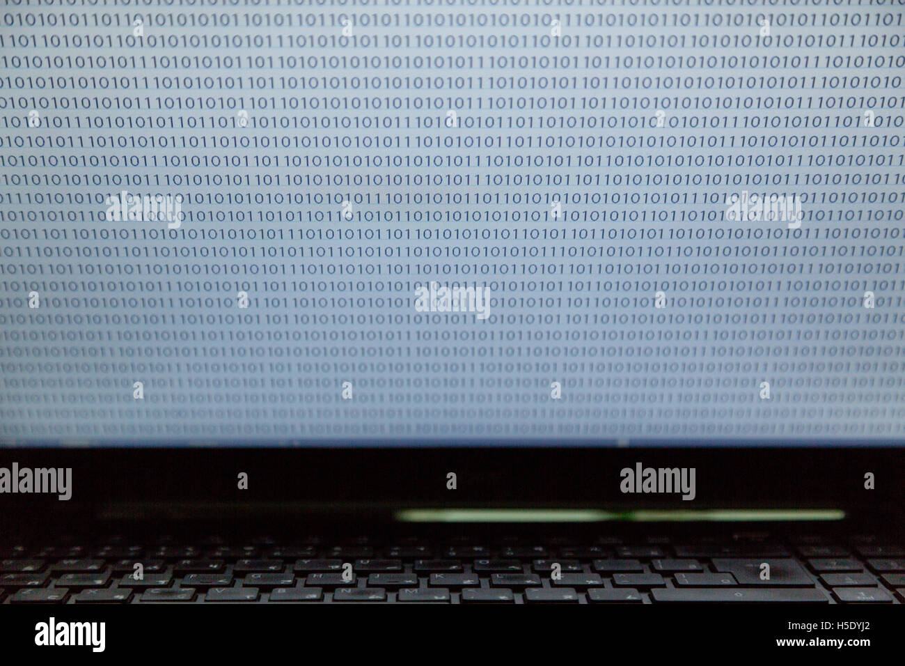 Black numbers zero and one as a texture on a white background, laptop ...