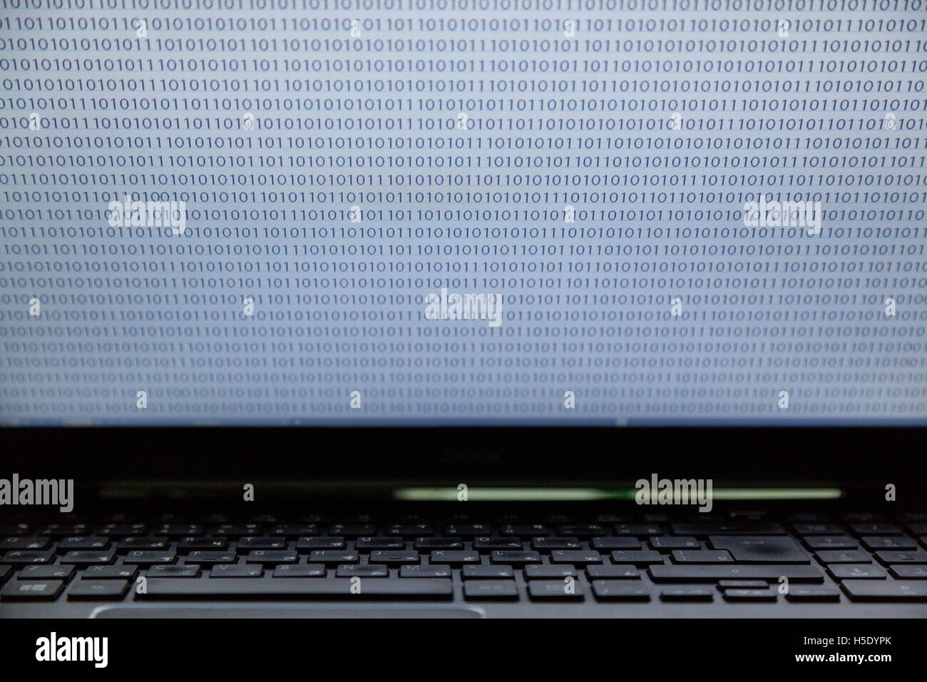 Black numbers zero and one as a texture on a white background, laptop ...