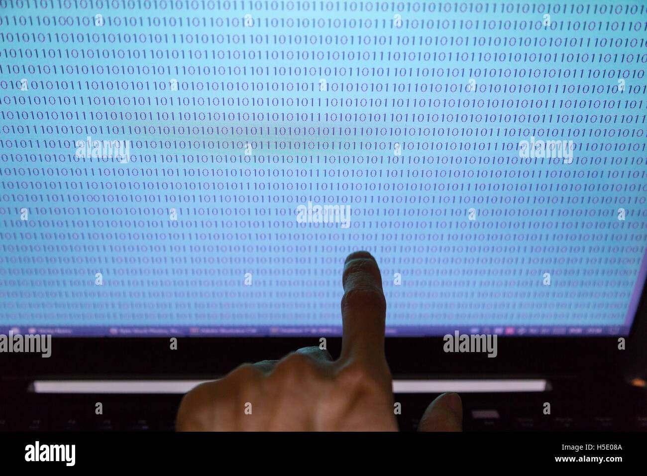 Black numbers zero and one as a texture on a blue background, hand on ...