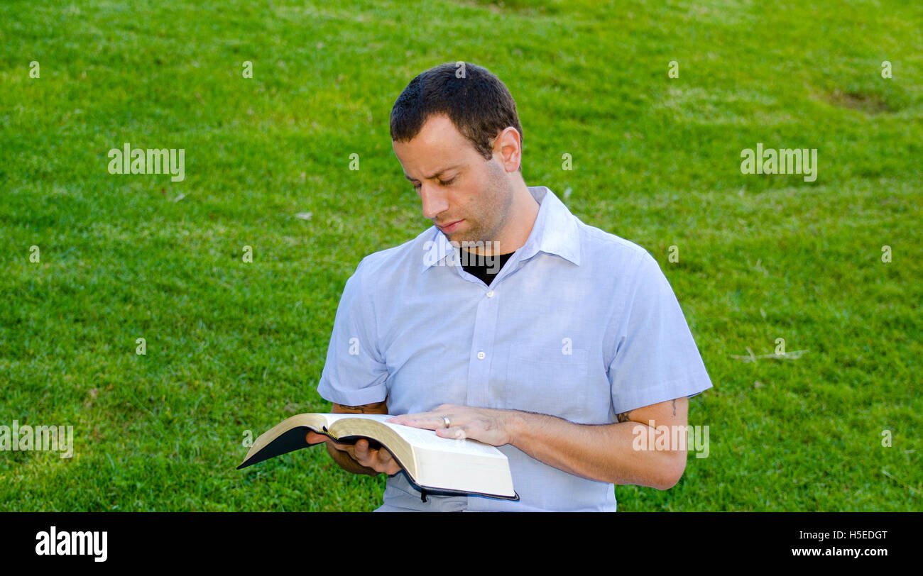 Man reading holy bible hi-res stock photography and images - Alamy