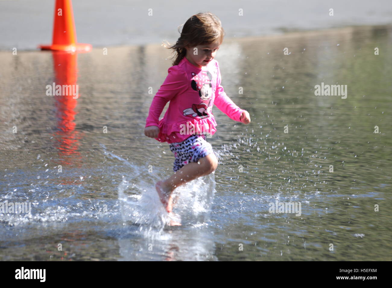 Little girl running in the water Stock Photo - Alamy