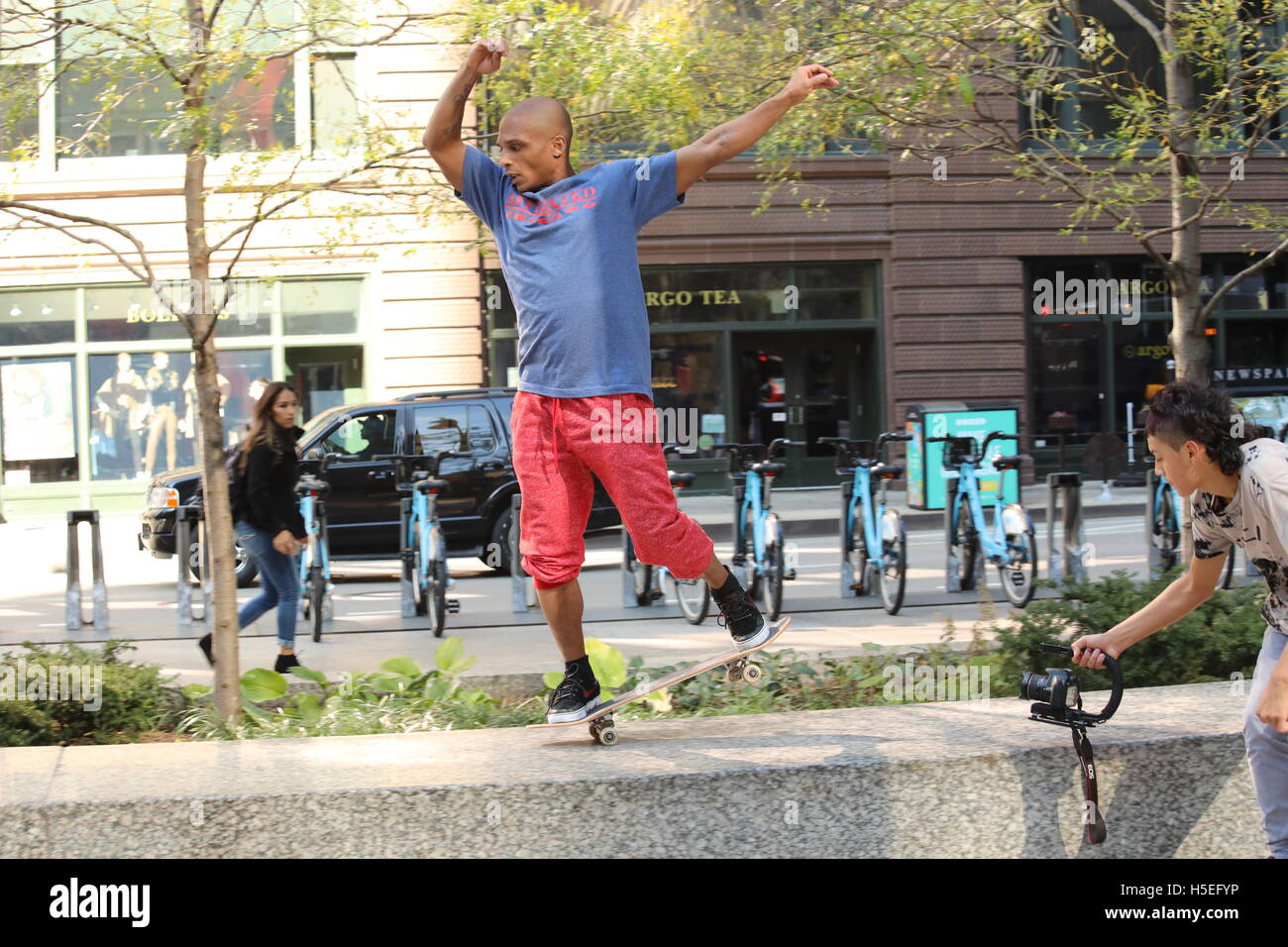 Filming man on a skateboard Stock Photo - Alamy