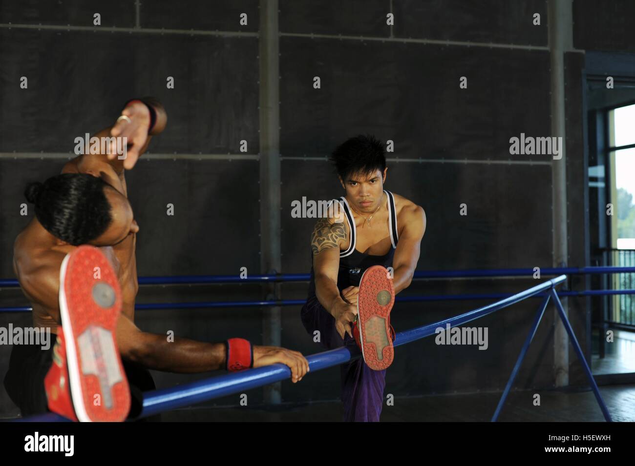 Asian man does fitness in the gym and Kung fu stick fighter Stock Photo ...