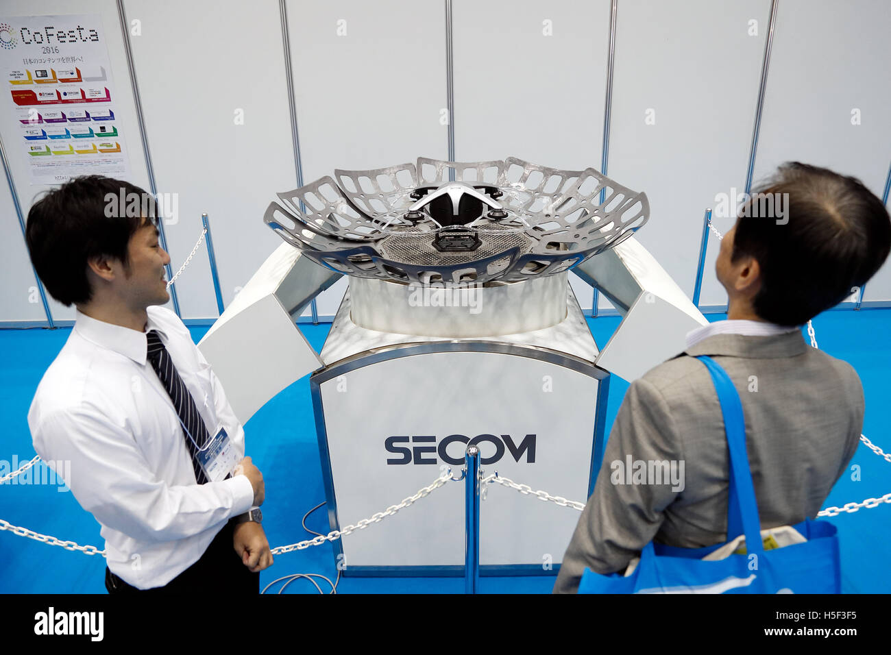 Tokyo, Japan. 20th October, 2016. Visitors look at a SECOM security ...