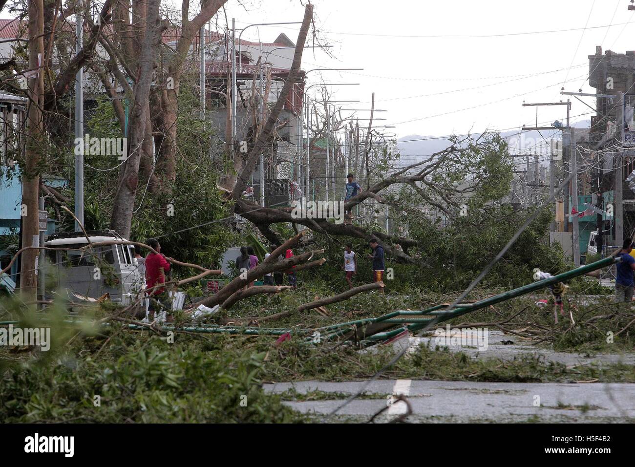 Cagayan Province. 20th Oct, 2016. Residents remove debris from toppled ...