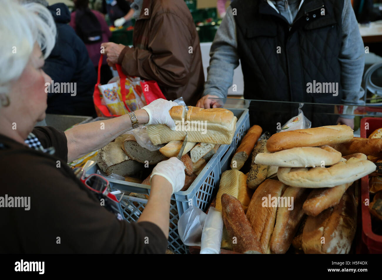 Volunteers of the Nuremberg food bank handing out food to people in ...