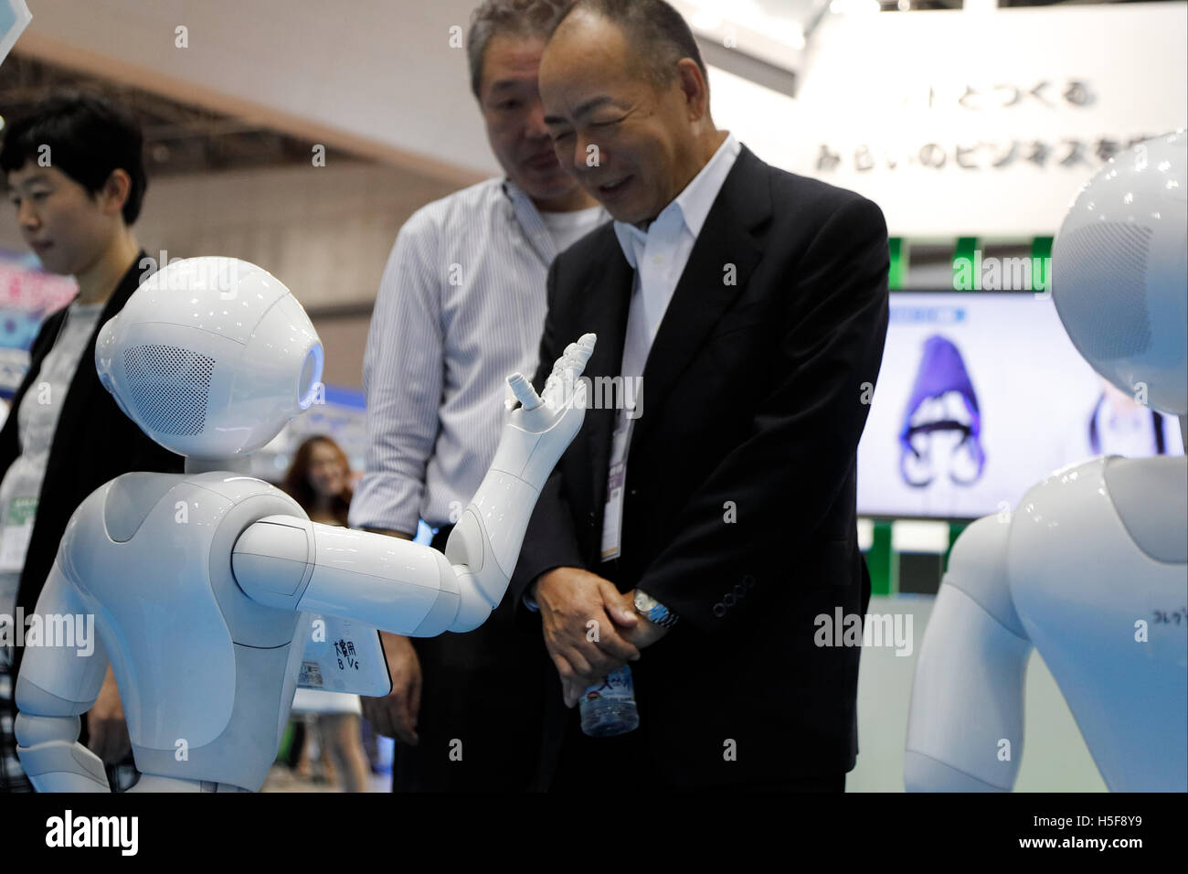 Visitors interact with SoftBank humanoid robot Pepper at Japan Robot Week 2016 in Tokyo Big ...