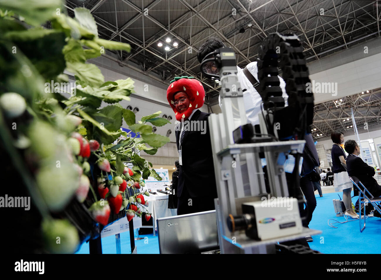 An exhibitor gives a demonstration of the Strawberry Harvest Robot that ...