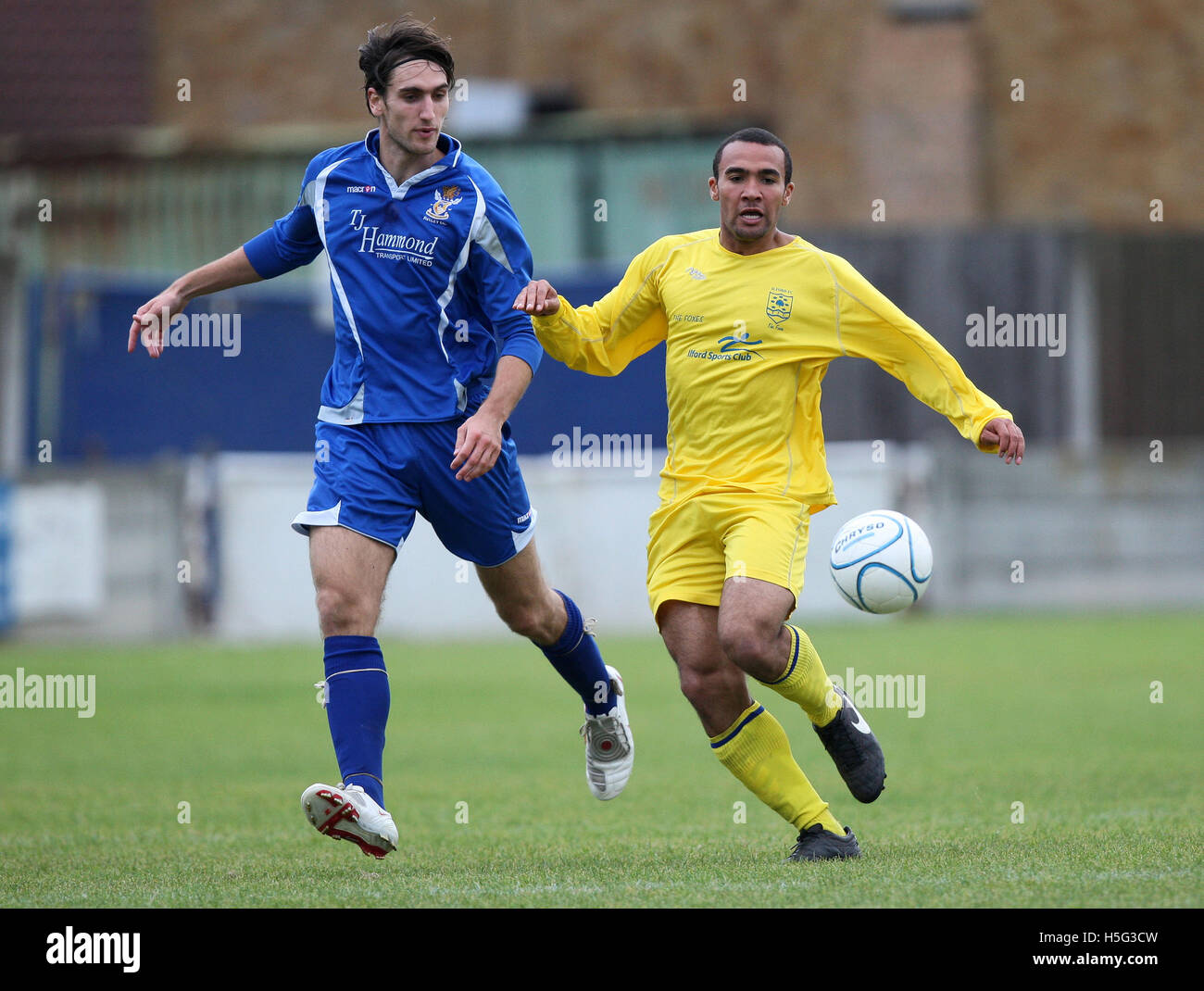 Chuck Duru of Ilford shields the ball from Ryan Doyle of Aveley ...