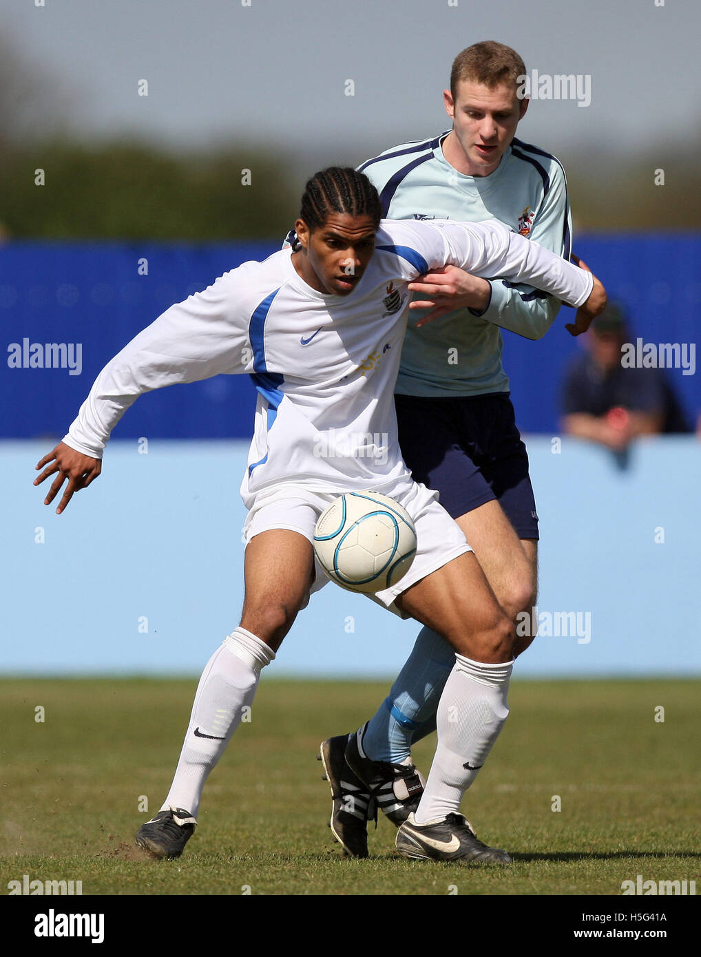 Jared Small of Redbridge shields the ball from Richard Ketchell of ...