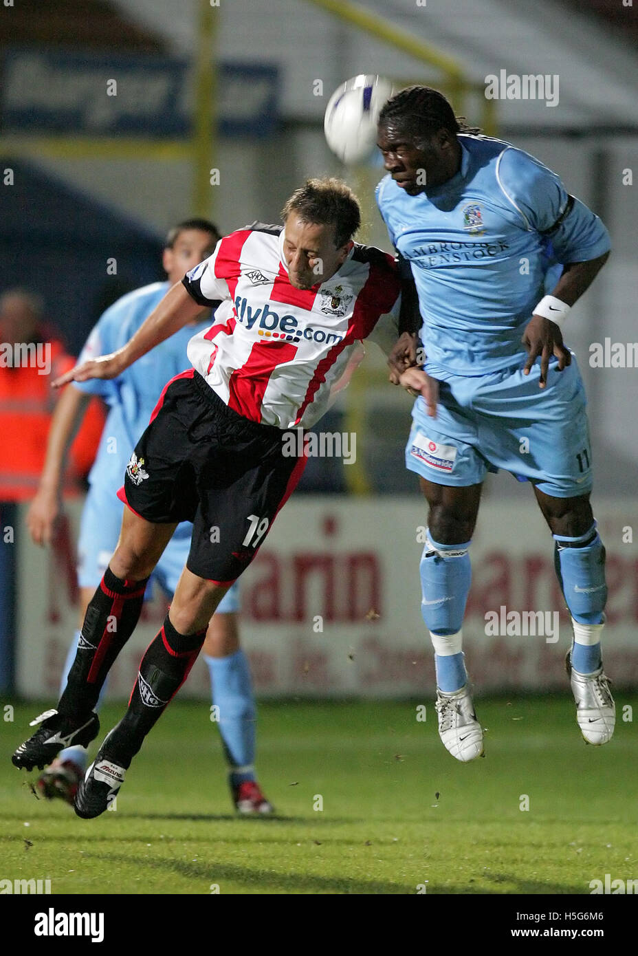 Aaron McLean gets in a header despite the attentions of City's Jon ...