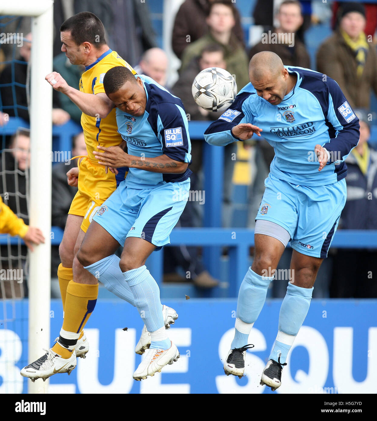 Lee Phillips of Torquay rises with Aaron O'Connor and Simon Downer of ...