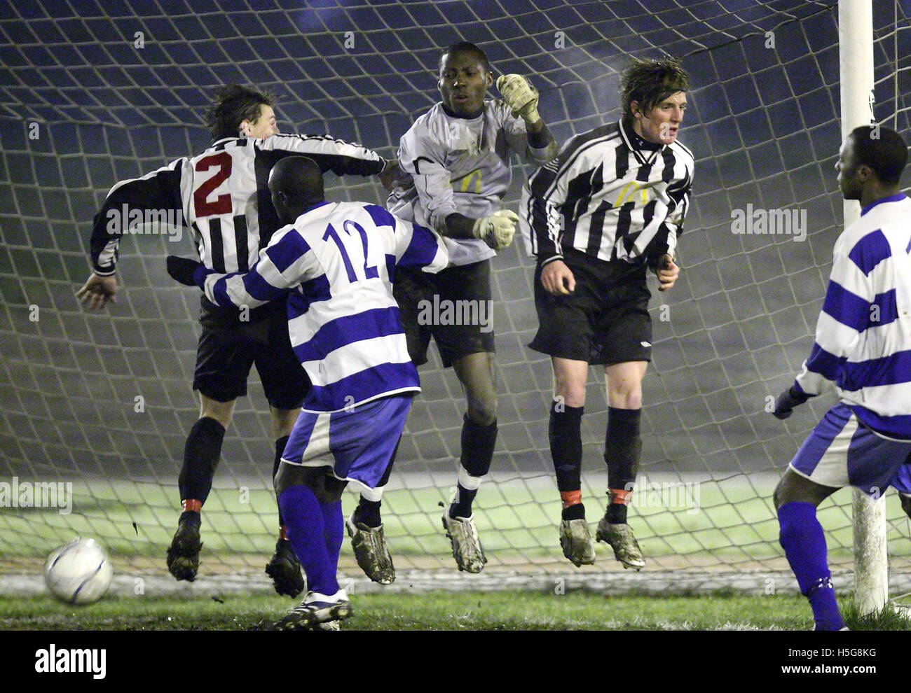 Goalmouth scramble - from left: Danny Smith (2) of Tilbury, Moses ...