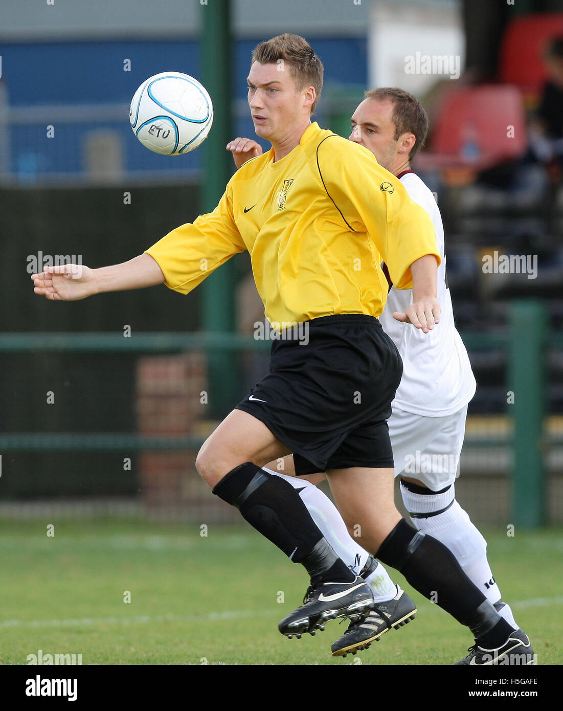 Max Cornhill of East Thurrock shields the ball from Barry Stevens ...
