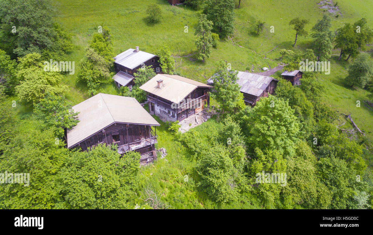Aerial view, Alpine chalets on Green Mountain slope under blue sky ...