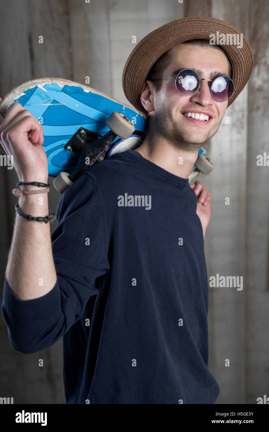fashionable guy with skateboard Stock Photo - Alamy
