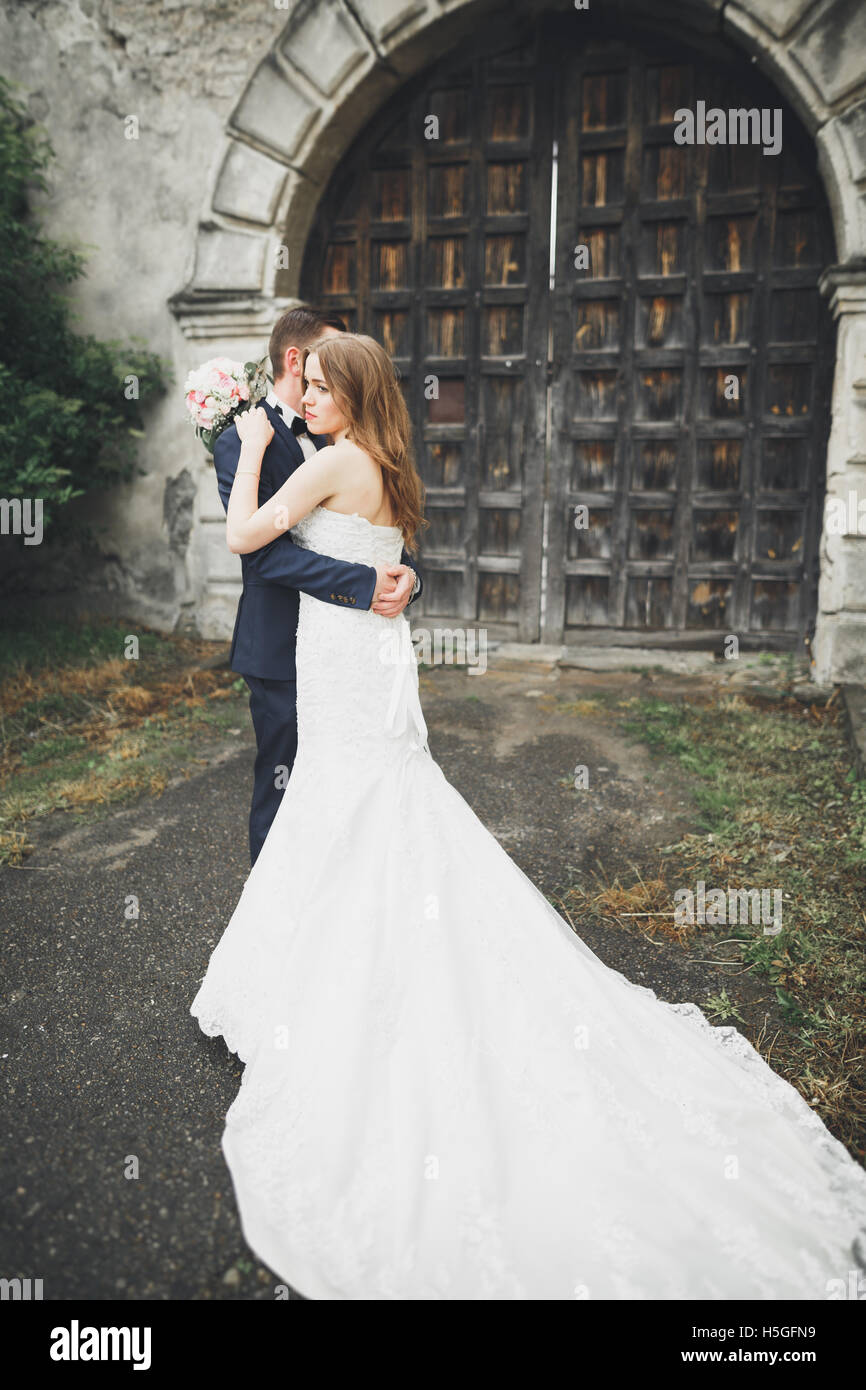 Happy wedding couple hugging and smiling each other on background old ...
