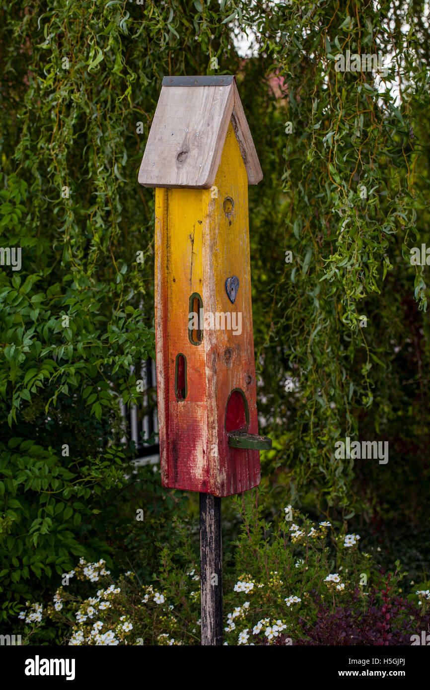Multi-colored box for birds with feed hopper Stock Photo - Alamy