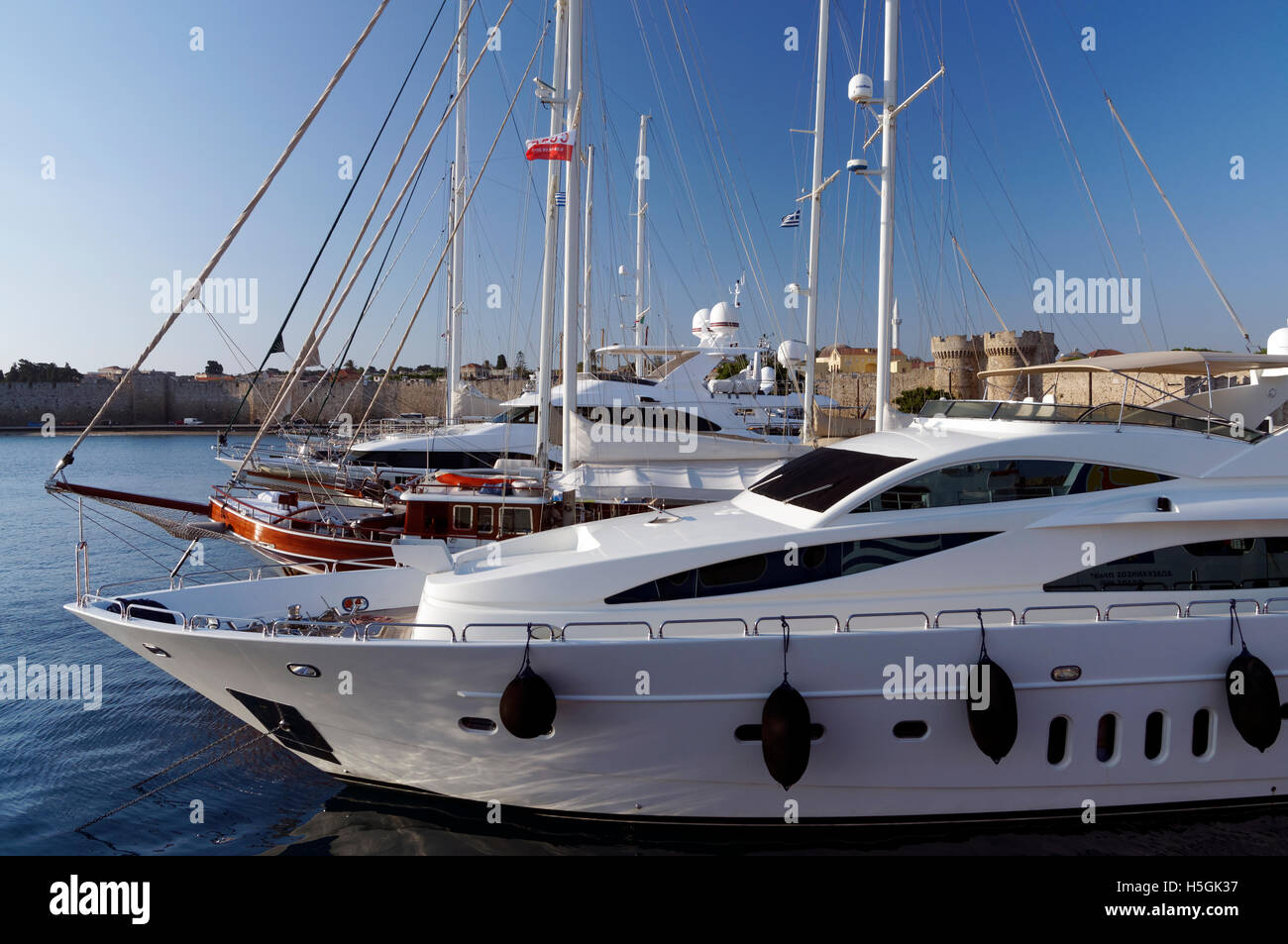 Boats in Rhodes Kalona Harbour with the Old Town Walls in the ...