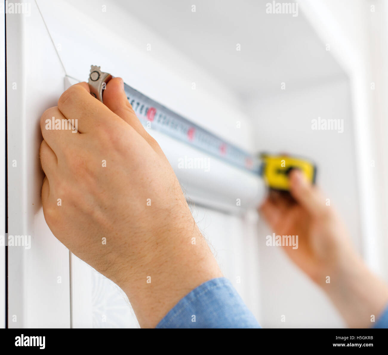 Man installing cassette roller blinds on windows Stock Photo - Alamy