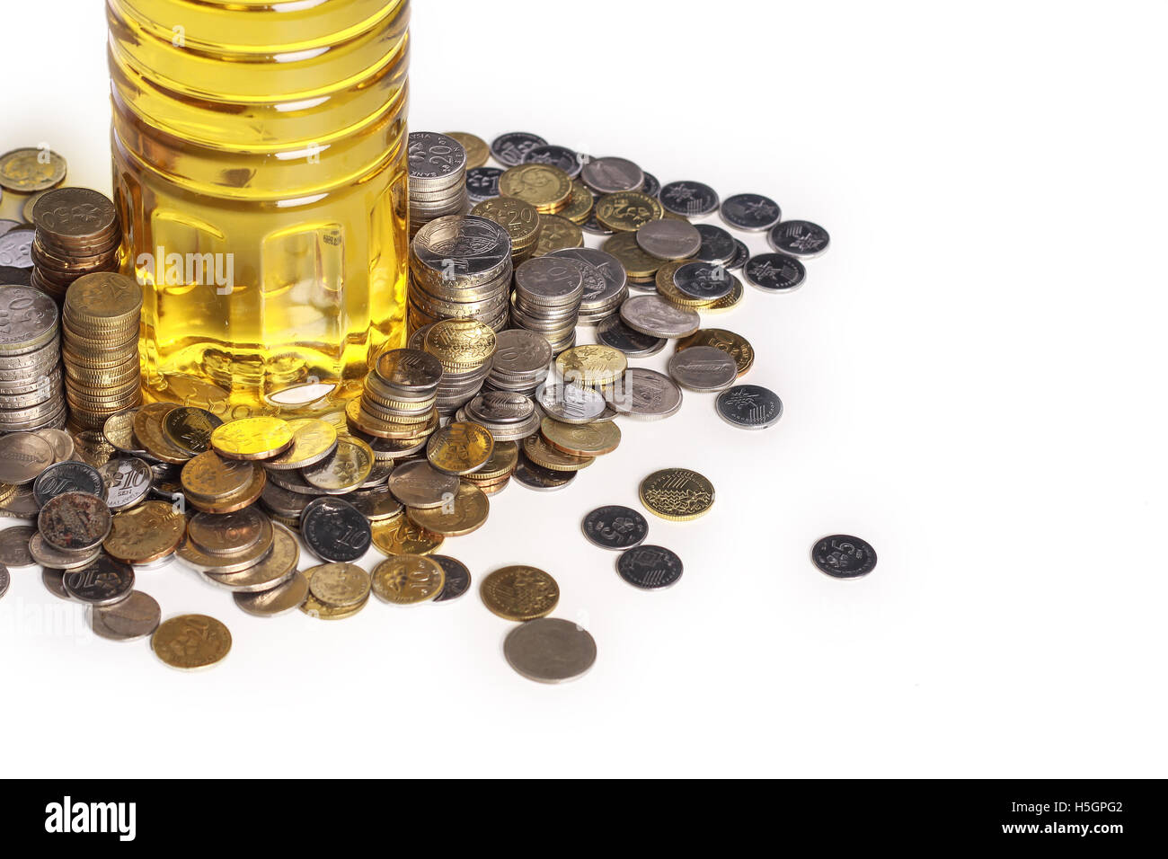 closed up coins and cooking oil isolated on white background Stock ...