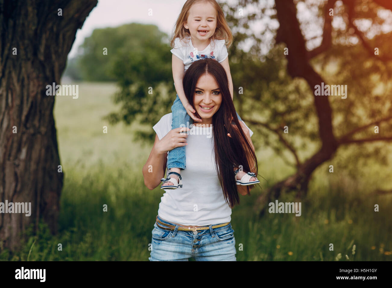 child near tree with mom Stock Photo - Alamy