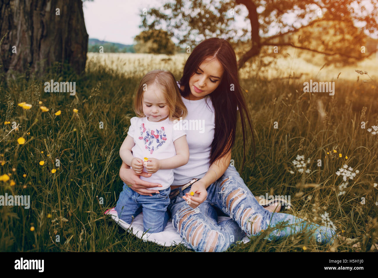 child near tree with mom Stock Photo - Alamy