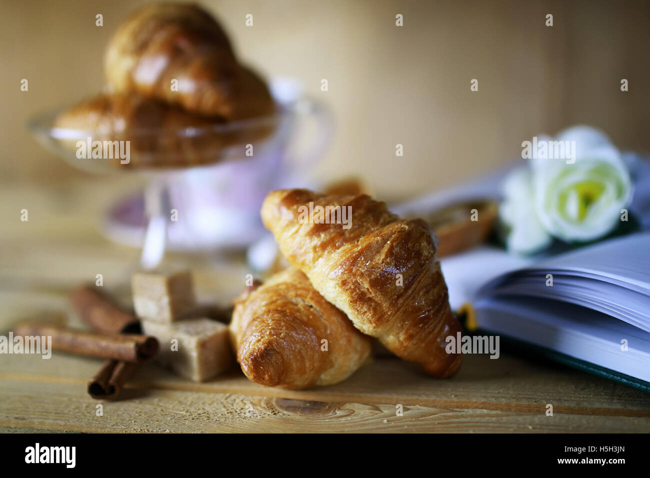 cup with tea croissant book Stock Photo - Alamy