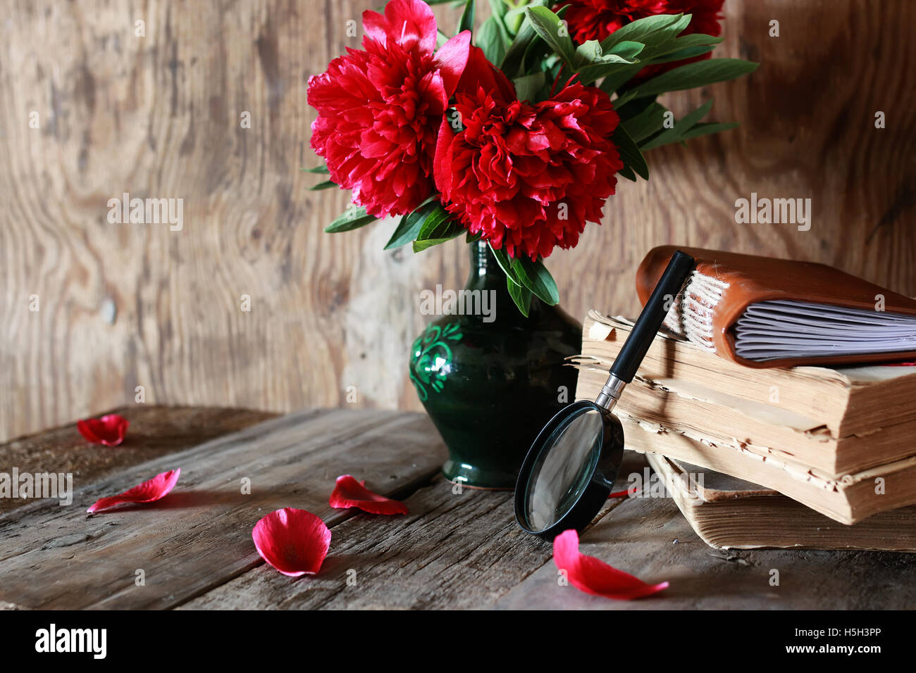 old book flower on wooden table Stock Photo - Alamy