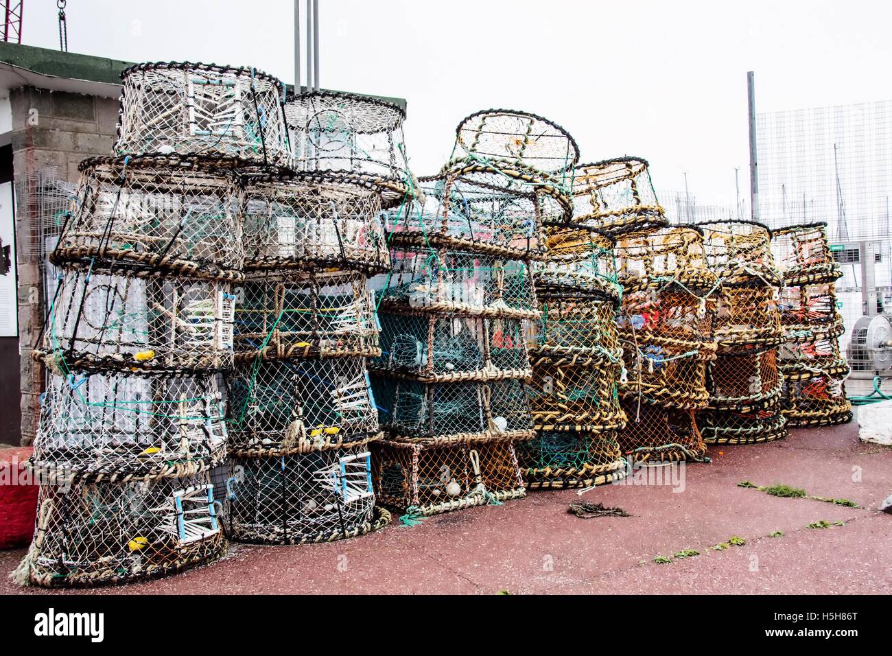 Fishing net and pots stacked on the harbour seafront of Torquay England ...