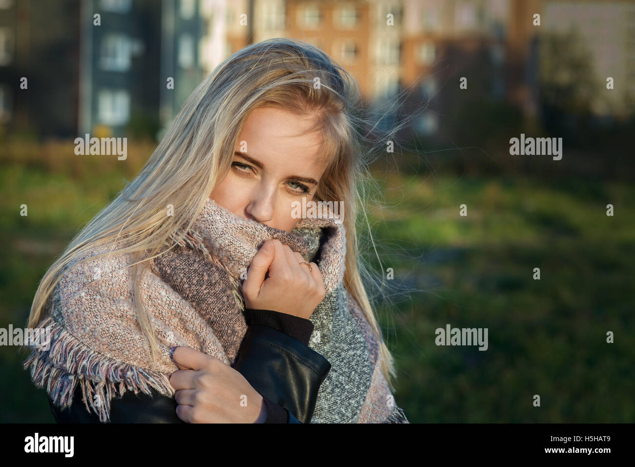 sad pensive blond girl in scarf toned image Stock Photo - Alamy