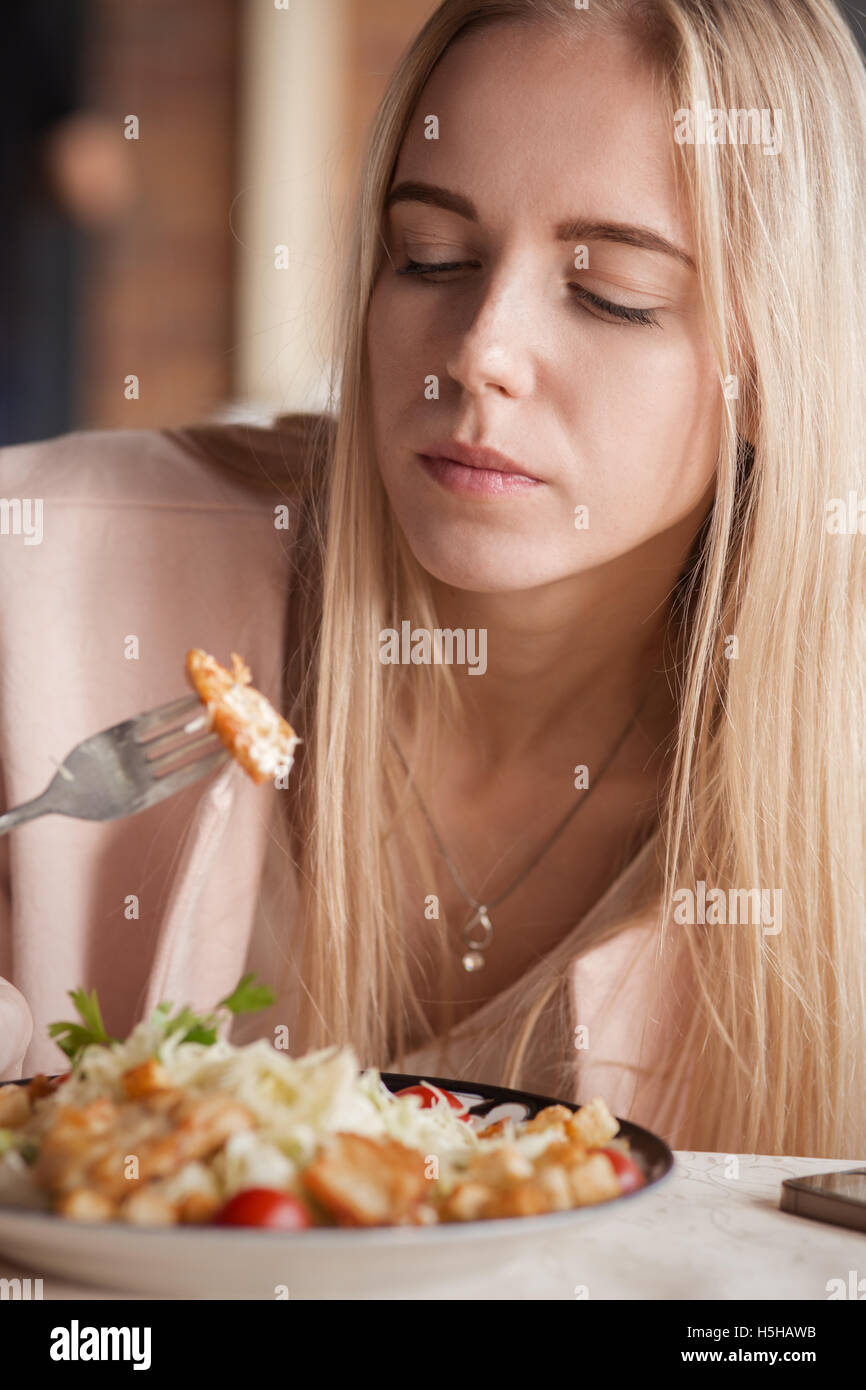 beautiful sad woman in cafe eating meat Stock Photo - Alamy