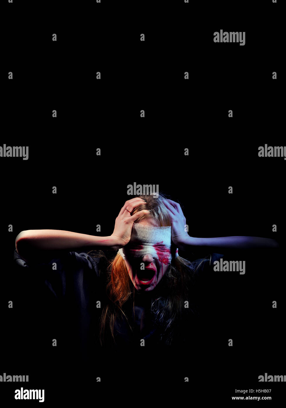 scared bloody girl screaming on black background with copyspace Stock ...