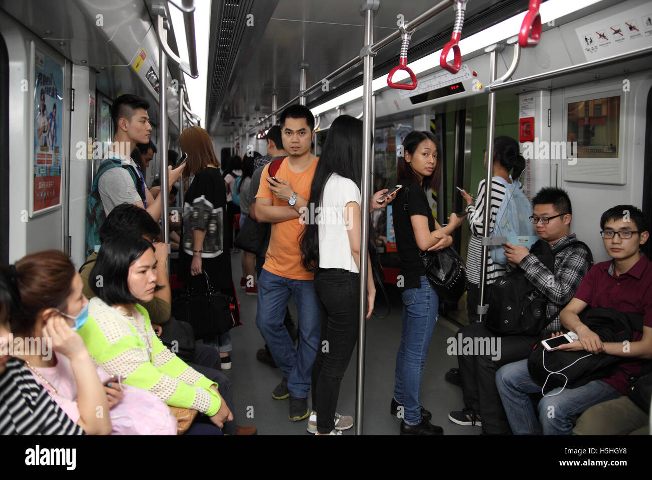 Chinese people ride the Guangzhou Metro train or subway, lots of them ...