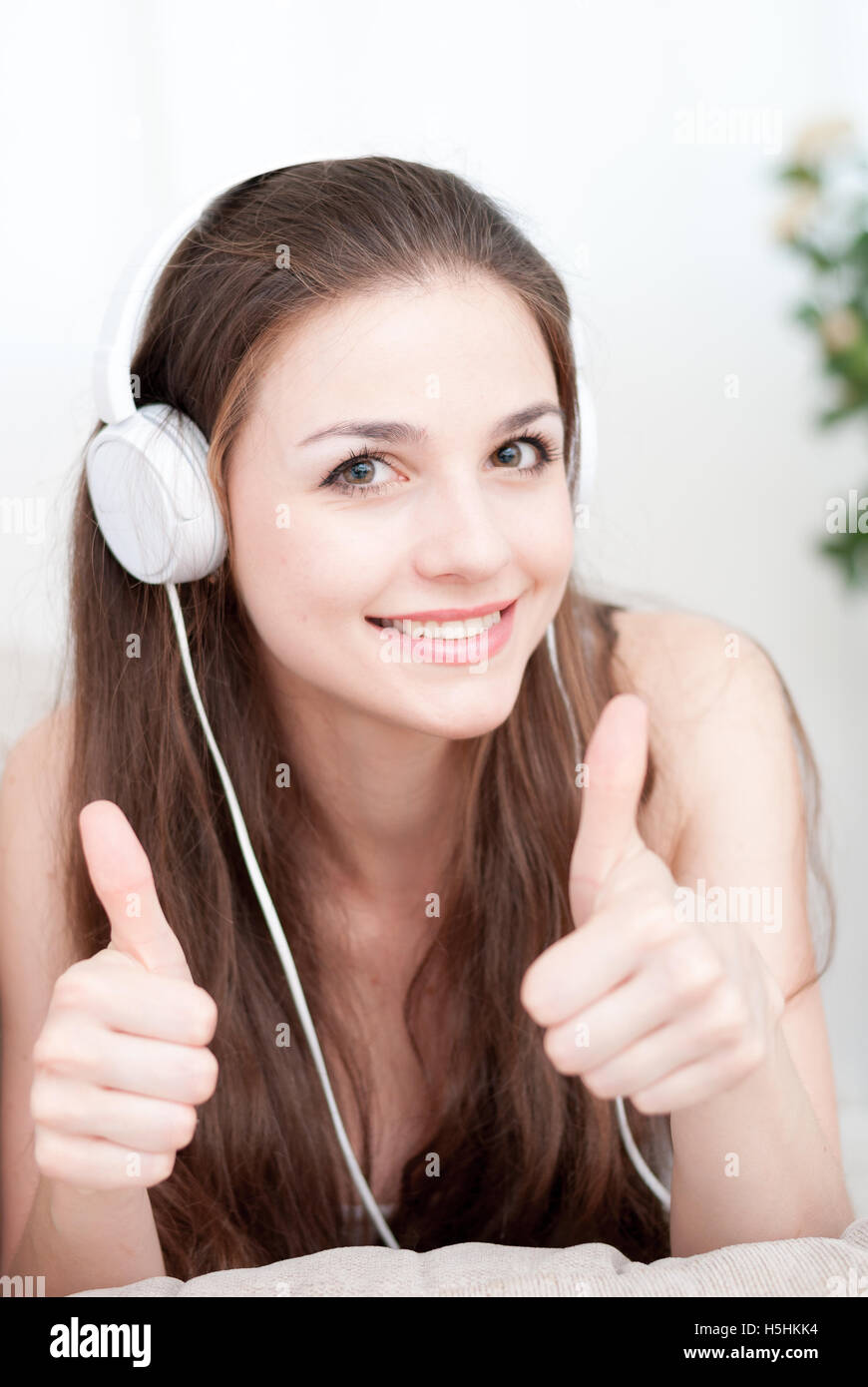 Happy girl on the couch at home in the living room Stock Photo - Alamy