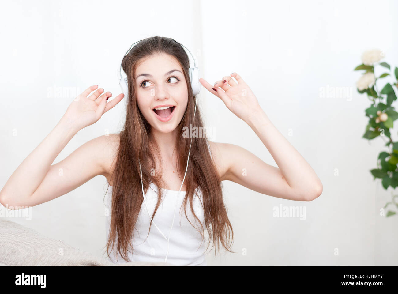 Happy girl on the couch at home in the living room Stock Photo - Alamy