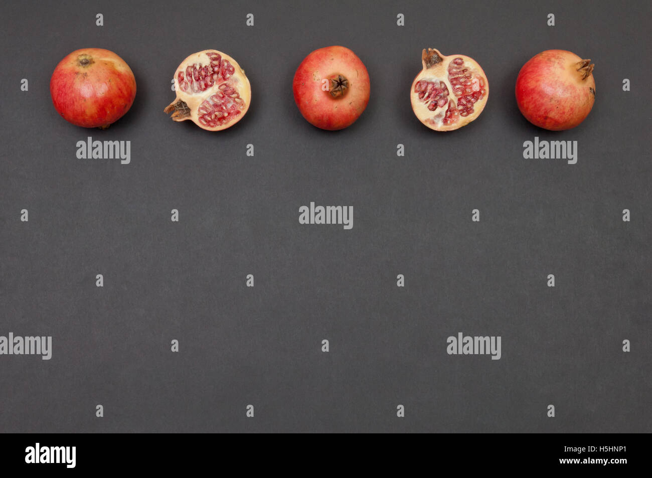 Pomegranates on gray background with copy space Stock Photo - Alamy