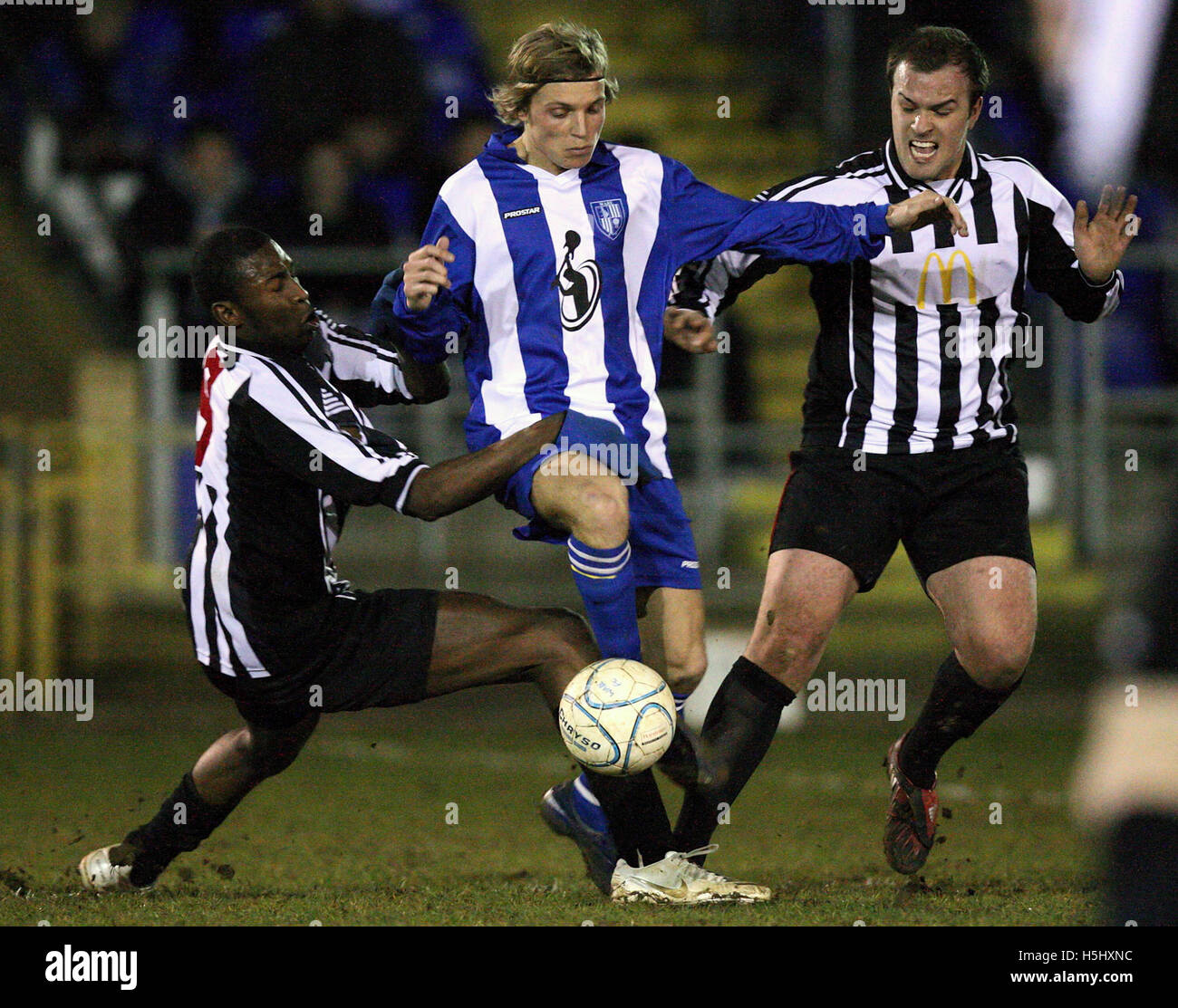 Danny Spendlove of Ware seeks a route between Tilbury pair Ajibola ...